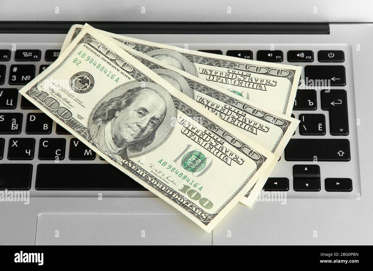 Money on laptop close hi-res stock photography and images - Alamy