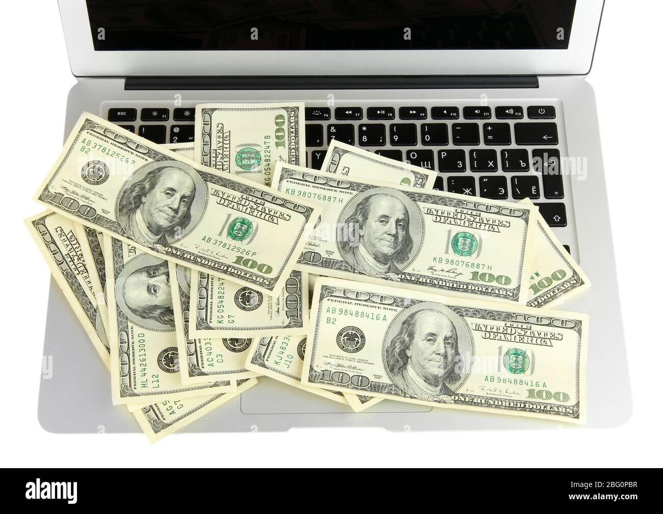 Money on laptop isolated on white Stock Photo - Alamy