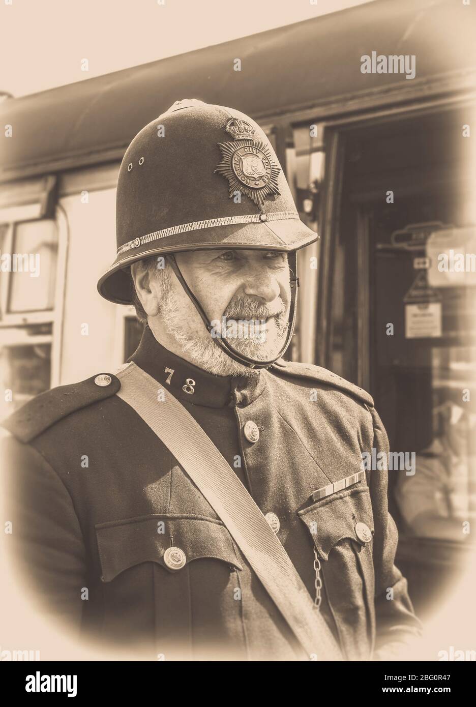 Old-fashioned sepia, front close up of vintage policeman, British bobby, in vintage uniform ...