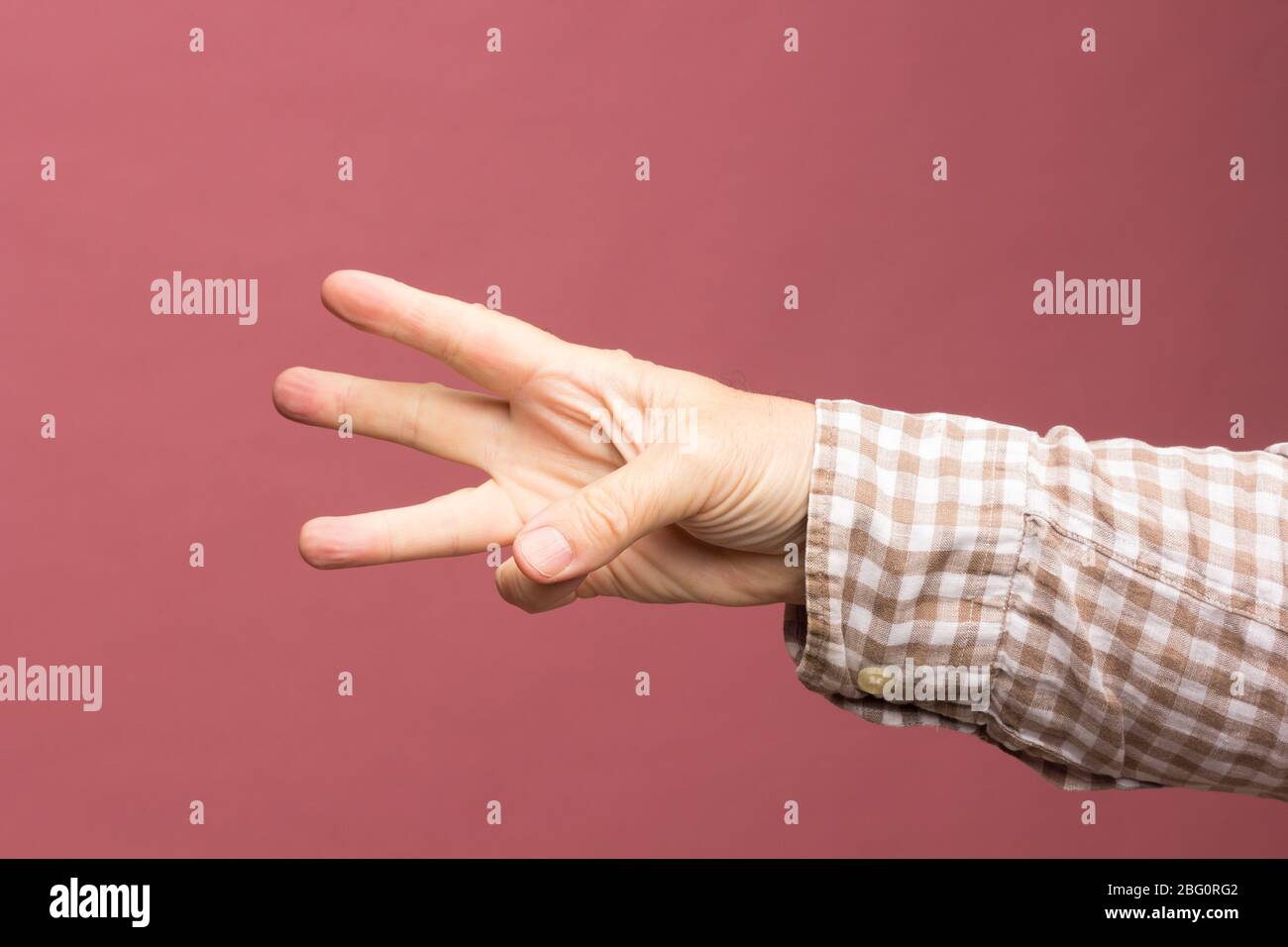 The perfection of an adult hand, with all five fingers, making signs ...