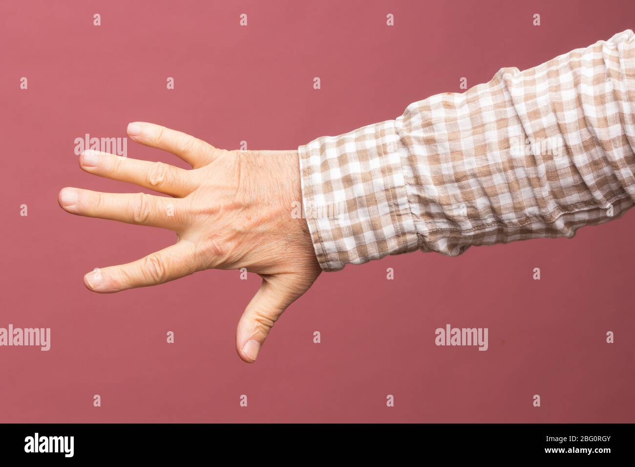 The perfection of an adult hand, with all five fingers, making signs ...