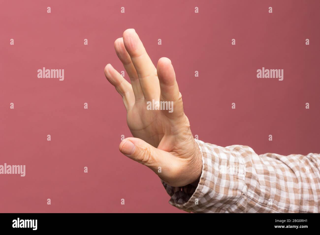 The perfection of an adult hand, with all five fingers, making signs ...