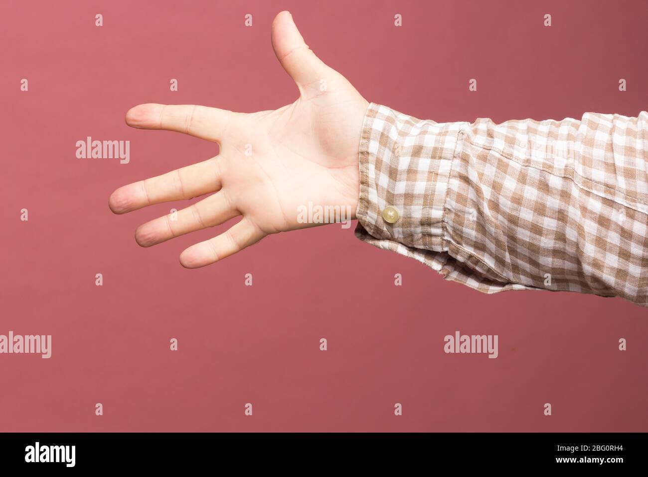 The perfection of an adult hand, with all five fingers, making signs ...