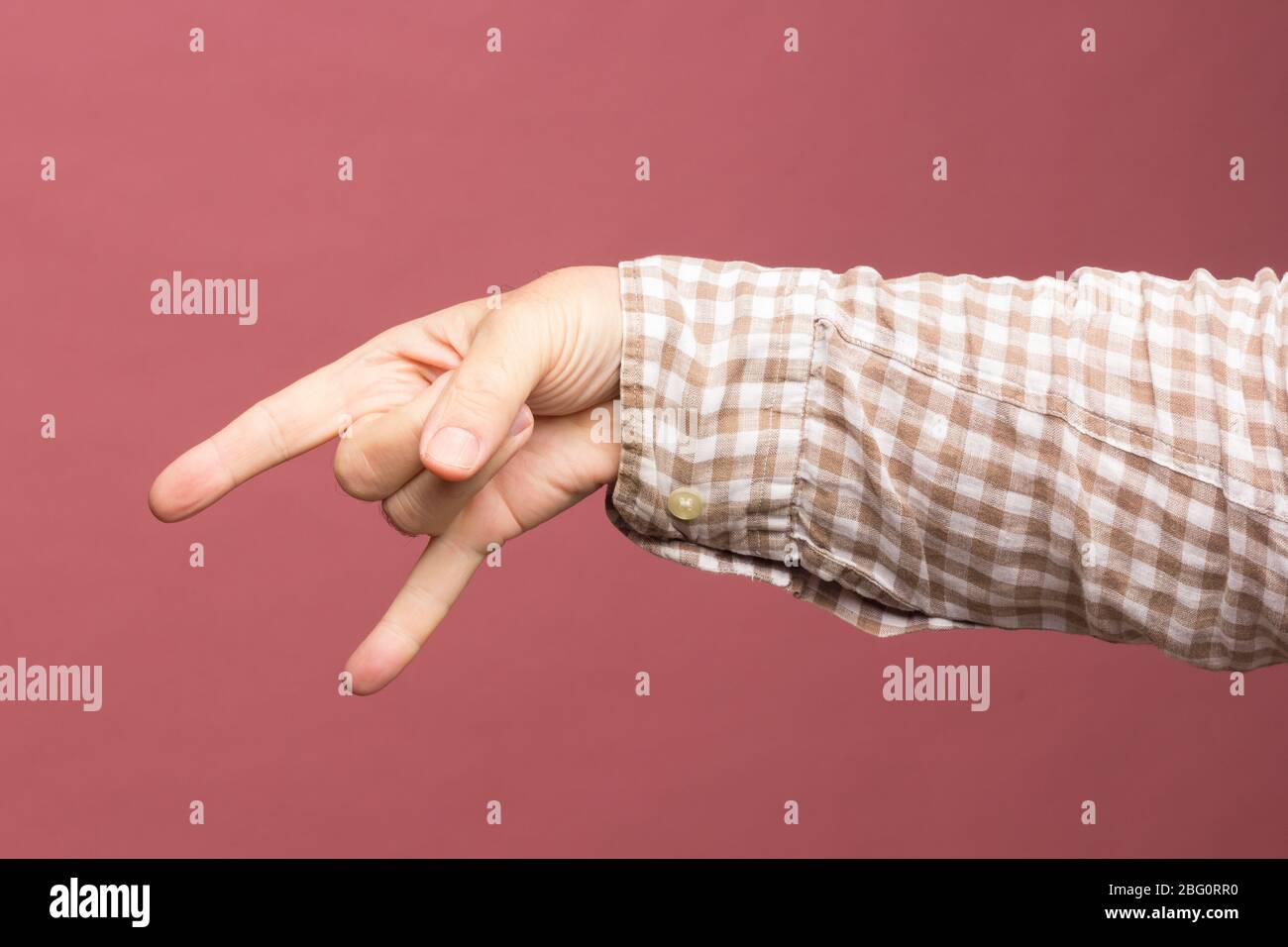 The perfection of an adult hand, with all five fingers, making signs ...