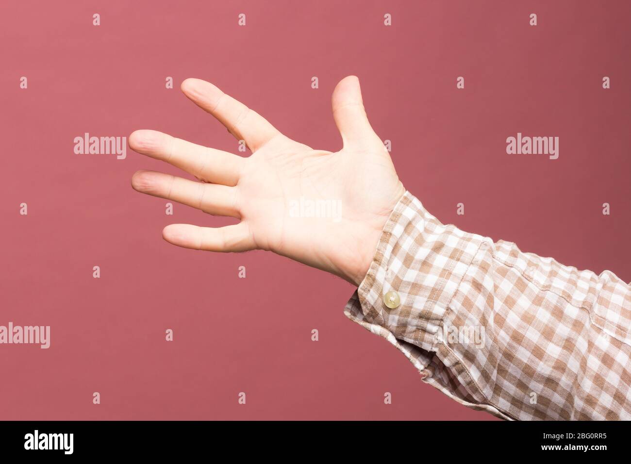 The perfection of an adult hand, with all five fingers, making signs ...