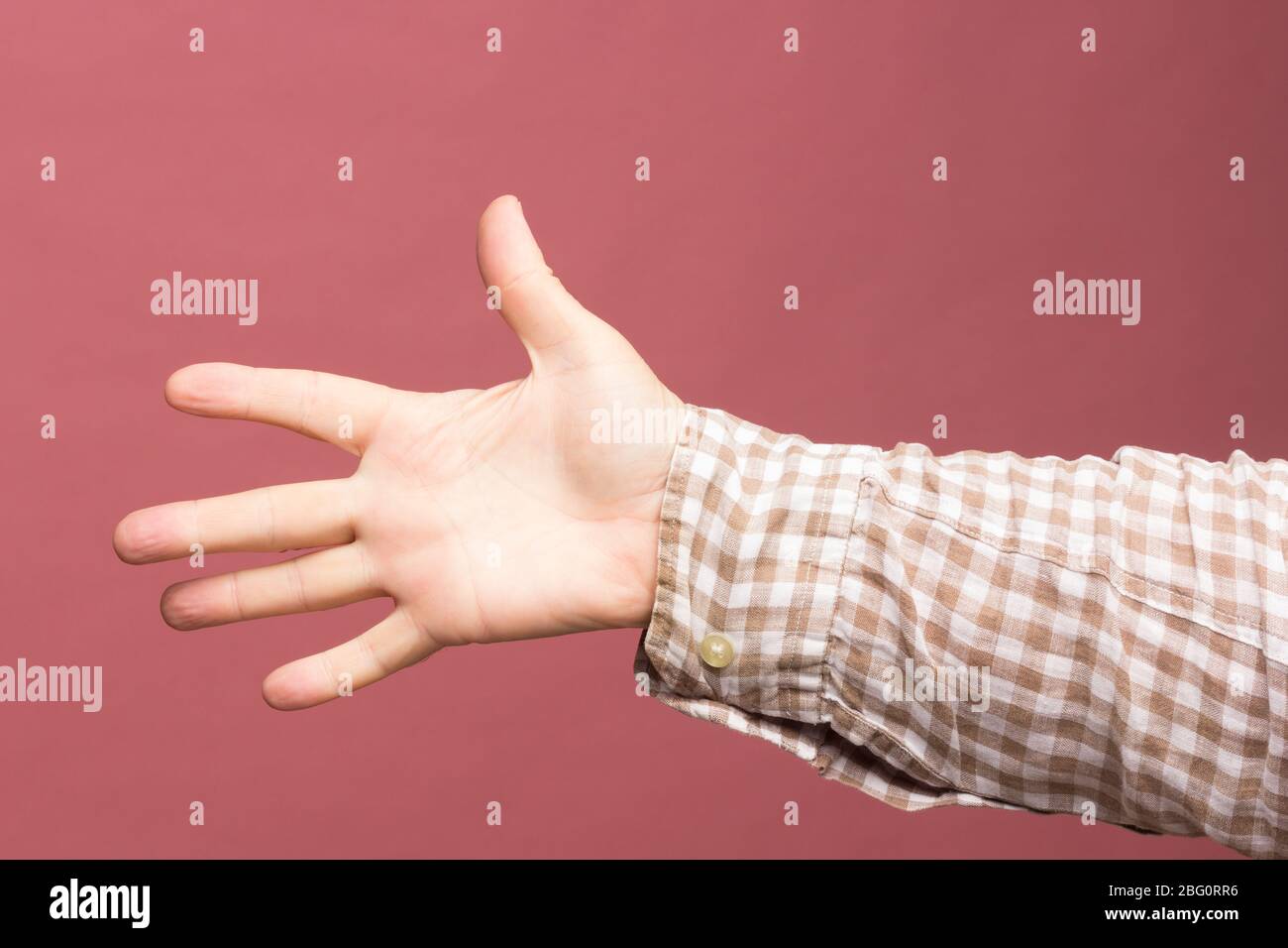 The perfection of an adult hand, with all five fingers, making signs ...