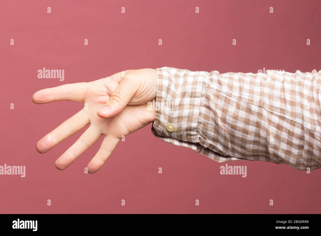 The perfection of an adult hand, with all five fingers, making signs ...