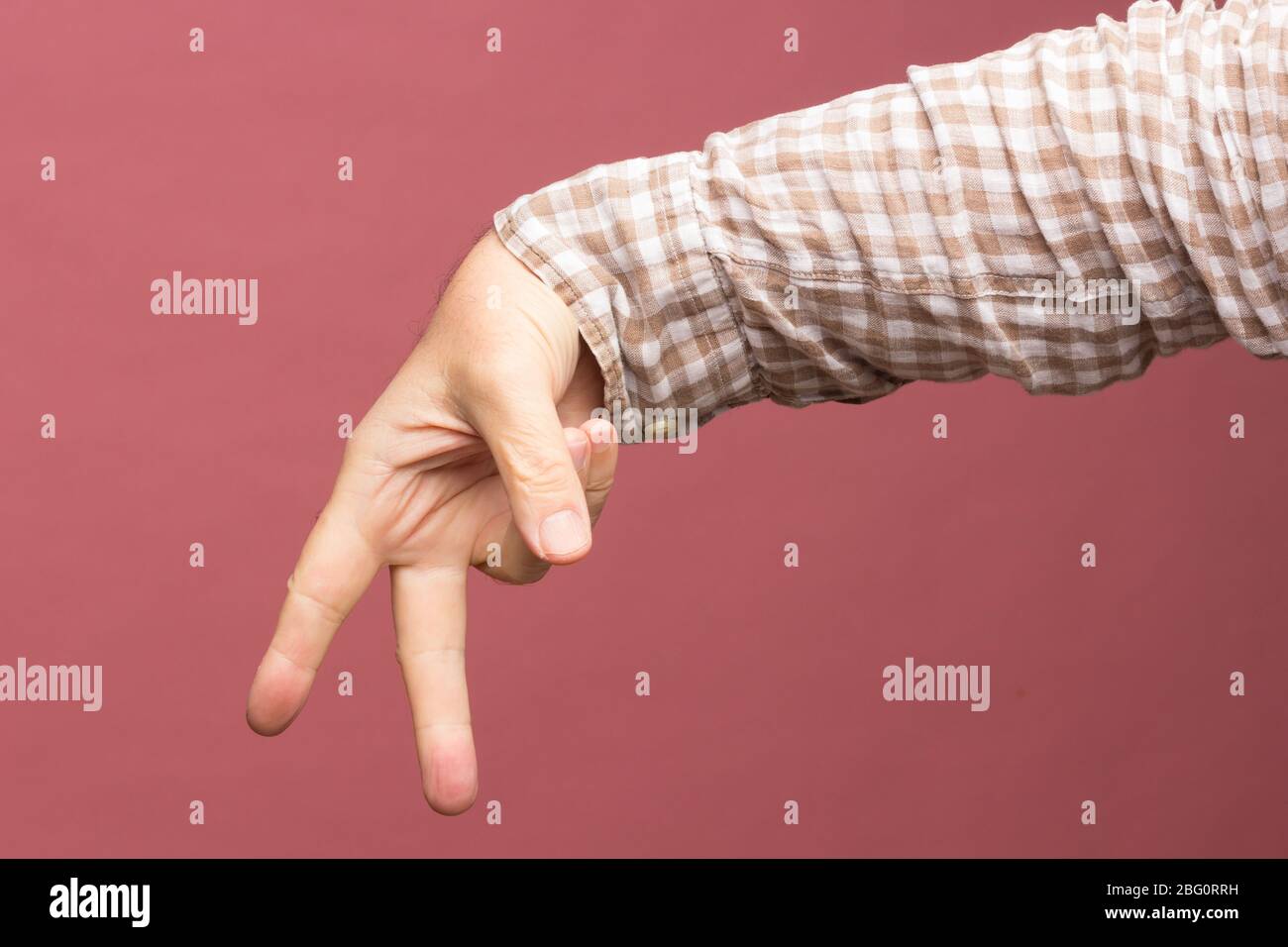 The perfection of an adult hand, with all five fingers, making signs ...