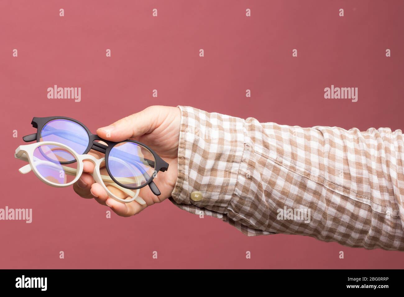 Designer glasses and lenses in the hand of an adult, glasses with ...