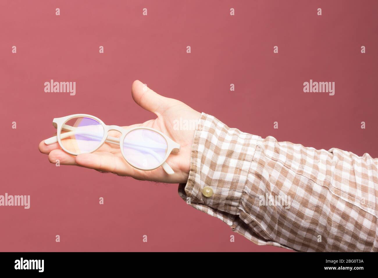 Designer glasses and lenses in the hand of an adult, glasses with ...