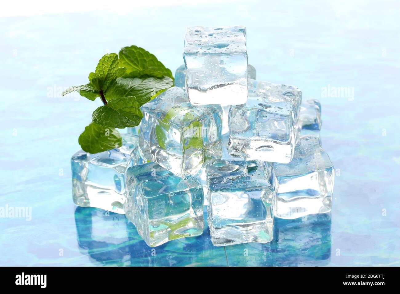 Ice with mint on light background Stock Photo - Alamy