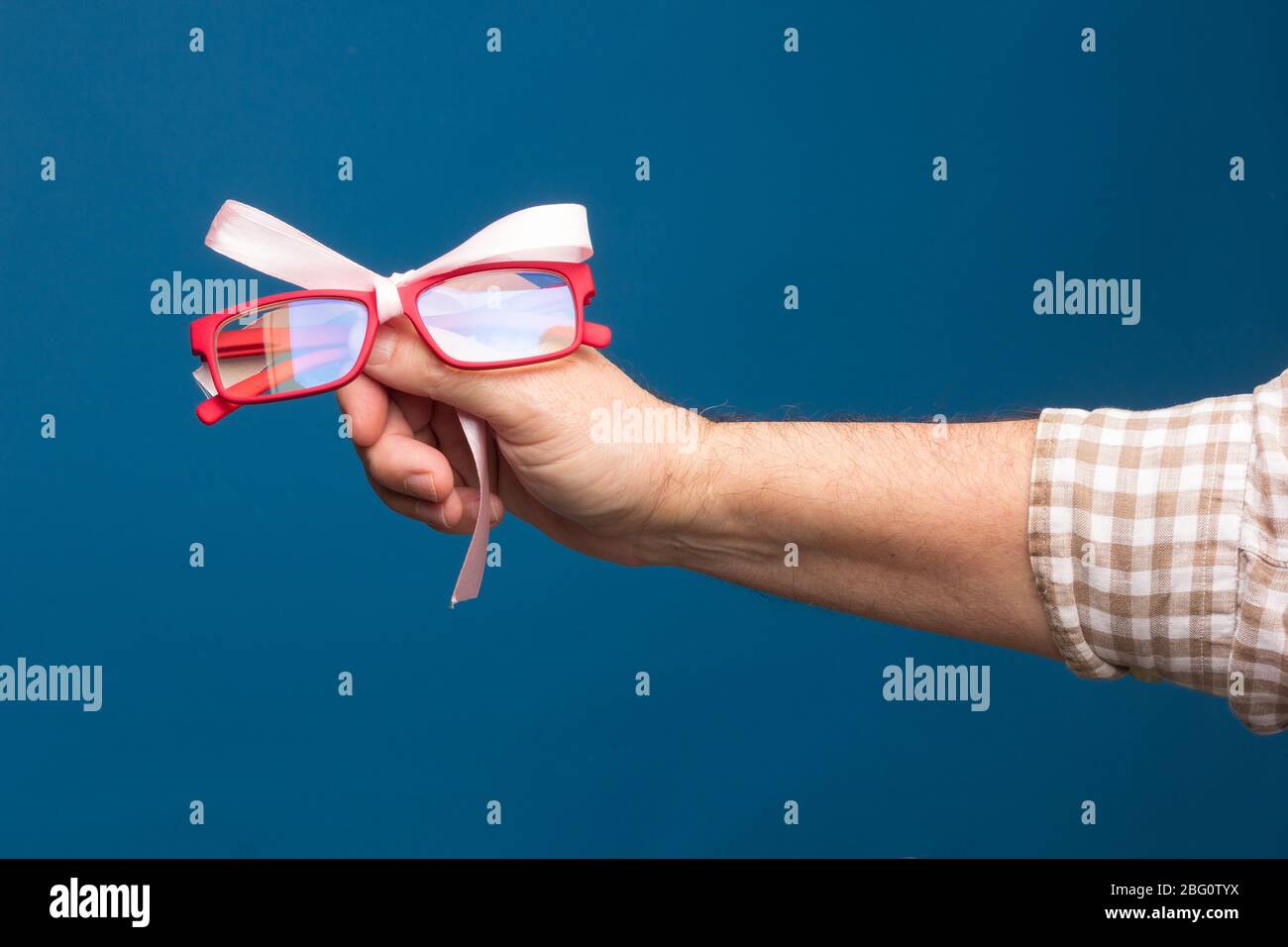 Designer glasses and lenses in the hand of an adult, glasses with ...
