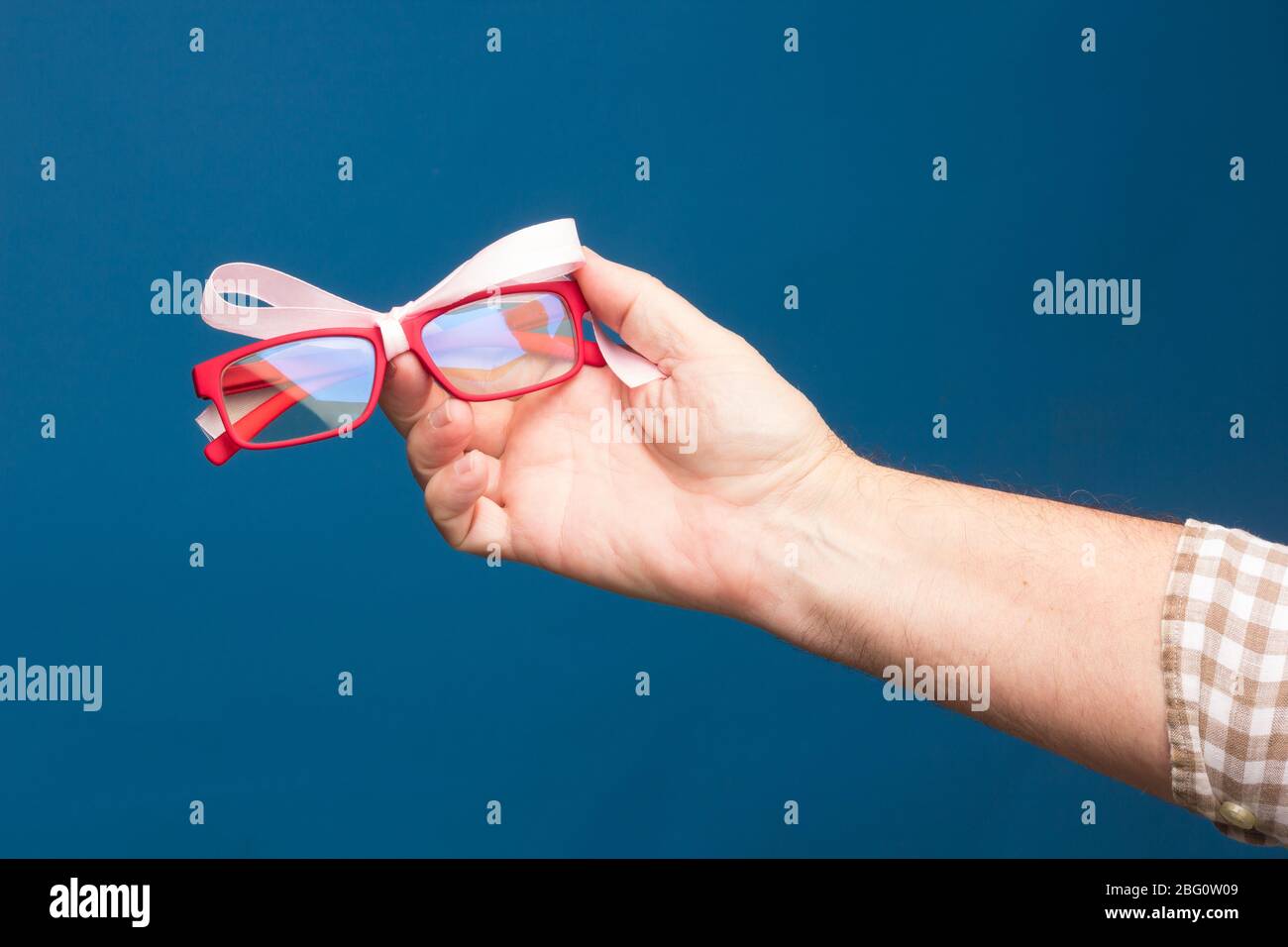 Designer glasses and lenses in the hand of an adult, glasses with ...