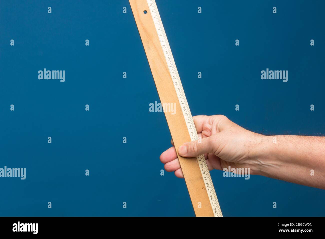Wooden ruler in a person's hand, a classic vintage ruler of a lifetime ...
