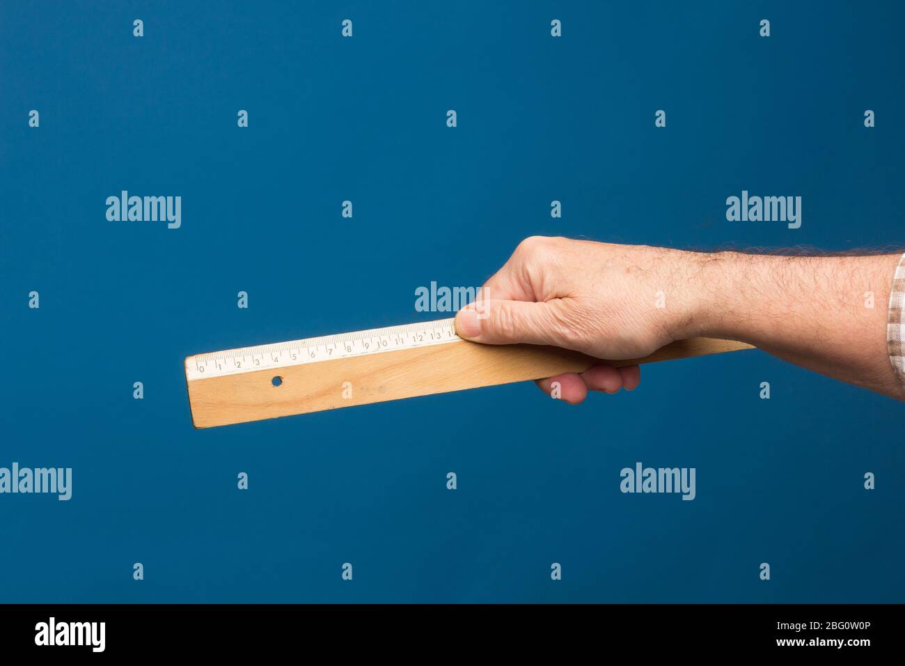 Wooden ruler in a person's hand, a classic vintage ruler of a lifetime ...
