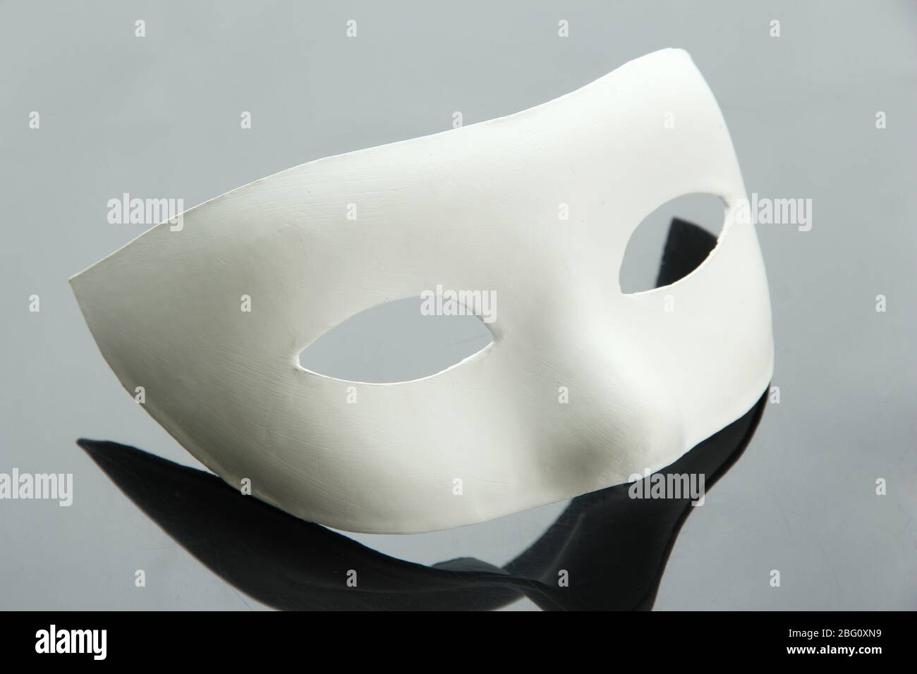 White mask, on grey background Stock Photo - Alamy