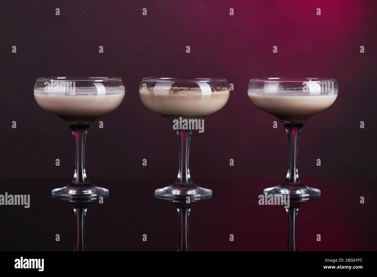 Cream cocktails on dark purple background Stock Photo - Alamy