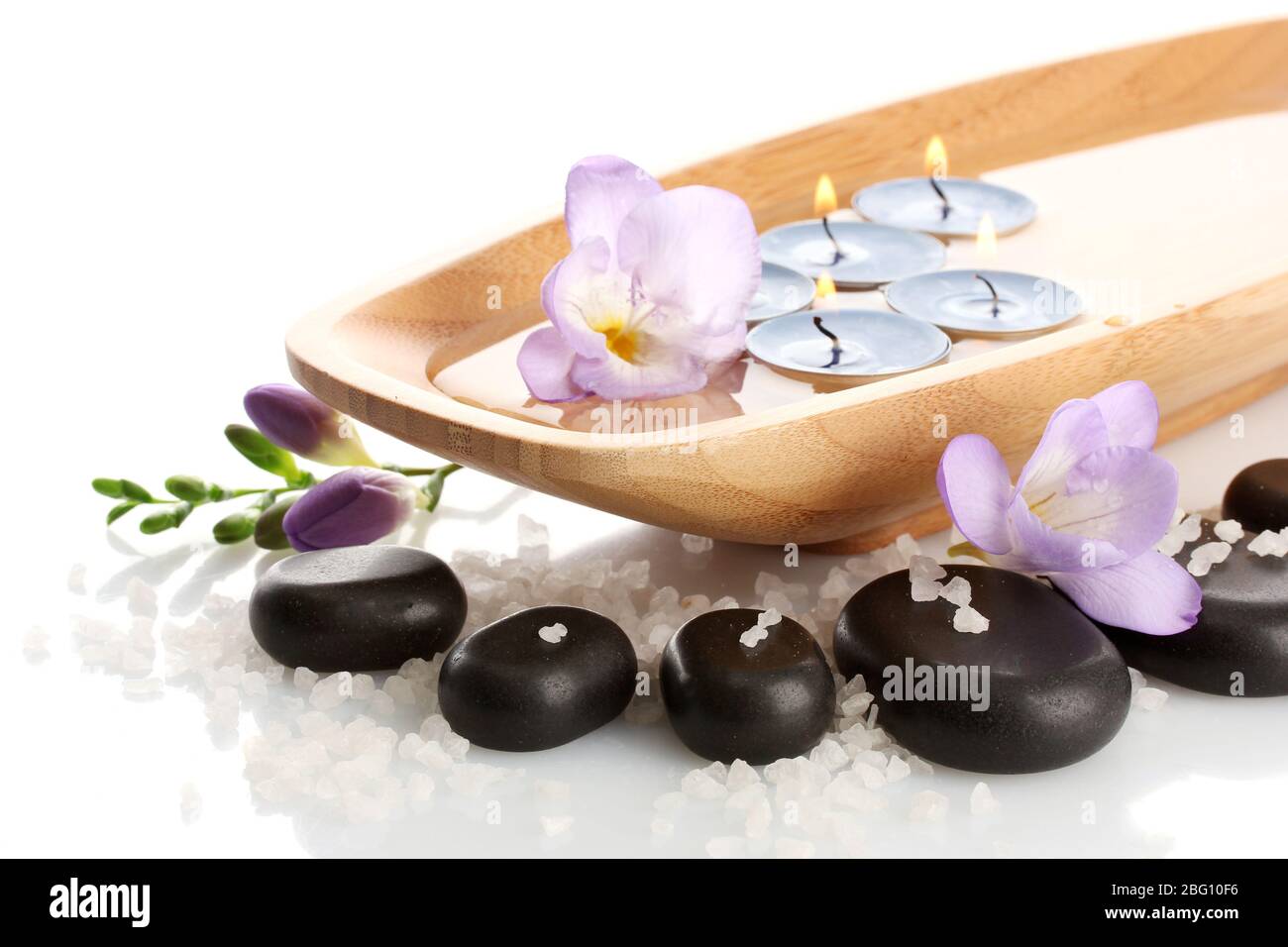 Beautiful spa setting with flowers, isolated on white Stock Photo - Alamy