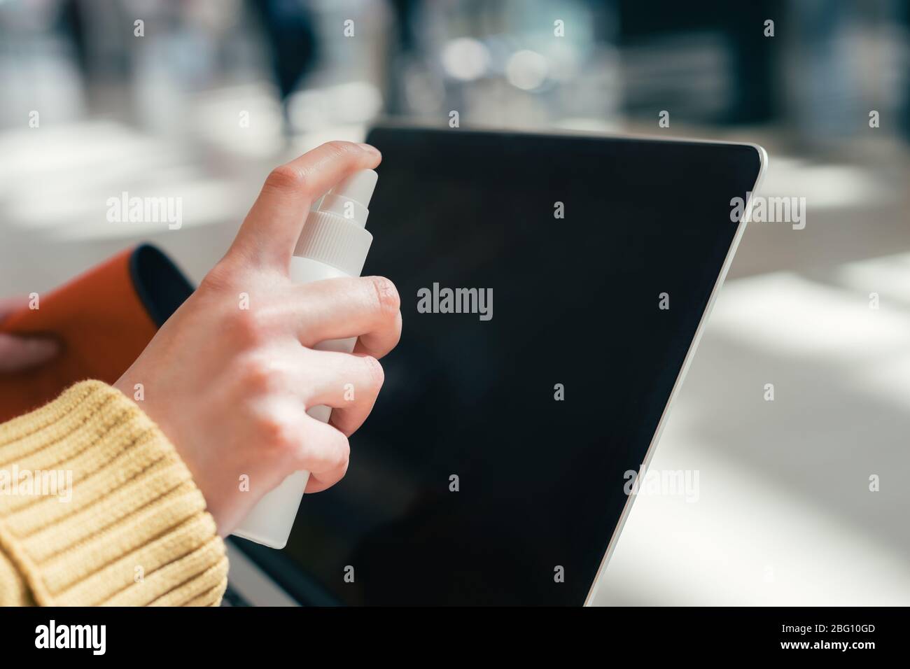 close up. the woman spraying the spray on the laptop screen Stock Photo ...