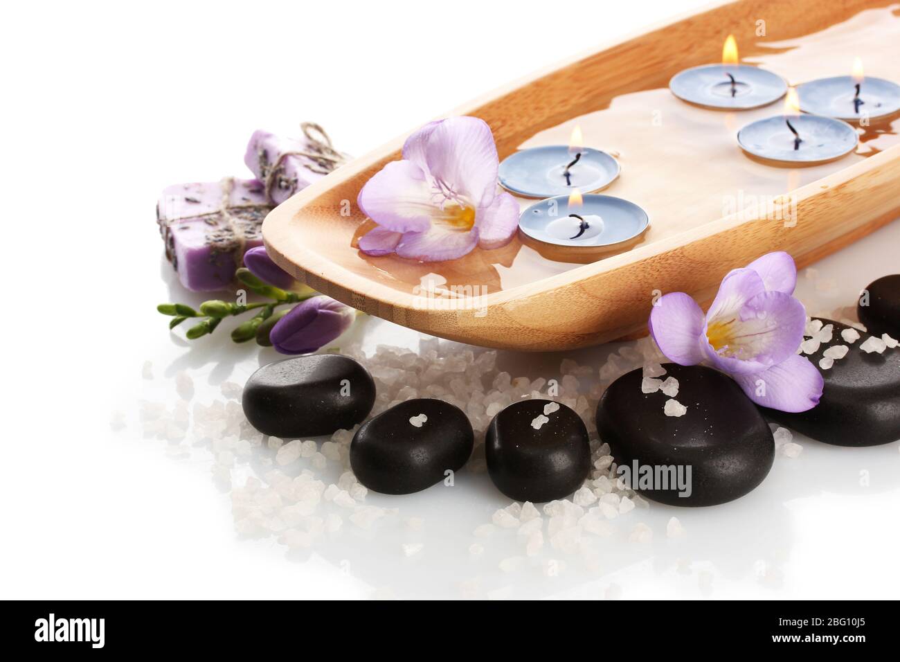 Beautiful spa setting with flowers, isolated on white Stock Photo - Alamy
