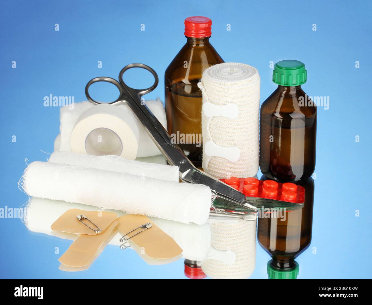 First aid kit for bandaging on blue background Stock Photo - Alamy