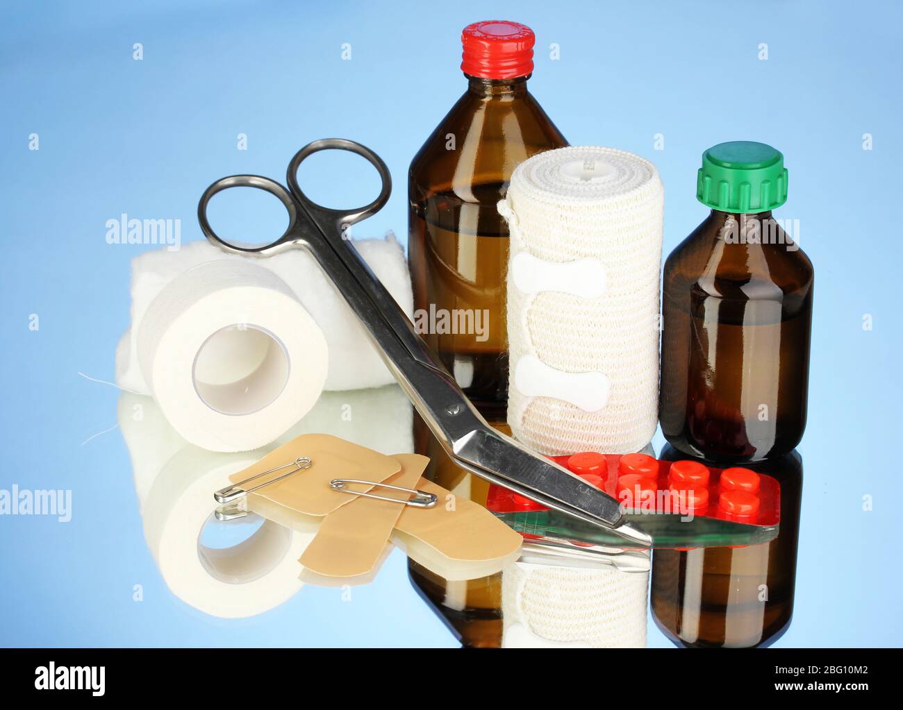 First aid kit for bandaging on blue background Stock Photo - Alamy