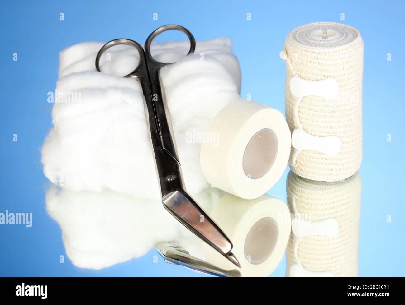 First aid kit for bandaging on blue background Stock Photo - Alamy