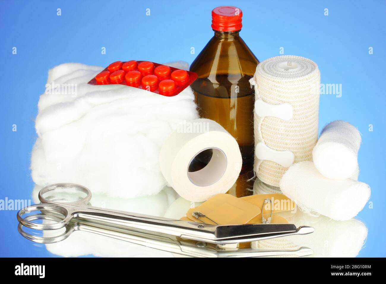 First aid kit for bandaging on blue background Stock Photo - Alamy