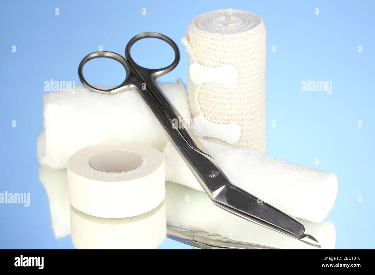 First aid kit for bandaging on blue background Stock Photo - Alamy