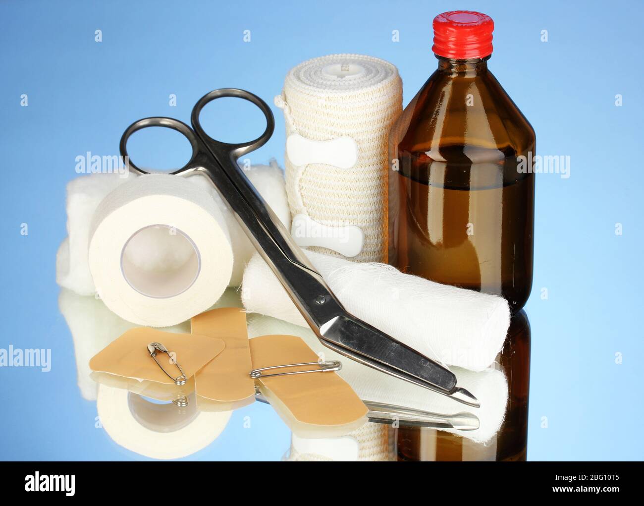 First aid kit for bandaging on blue background Stock Photo - Alamy