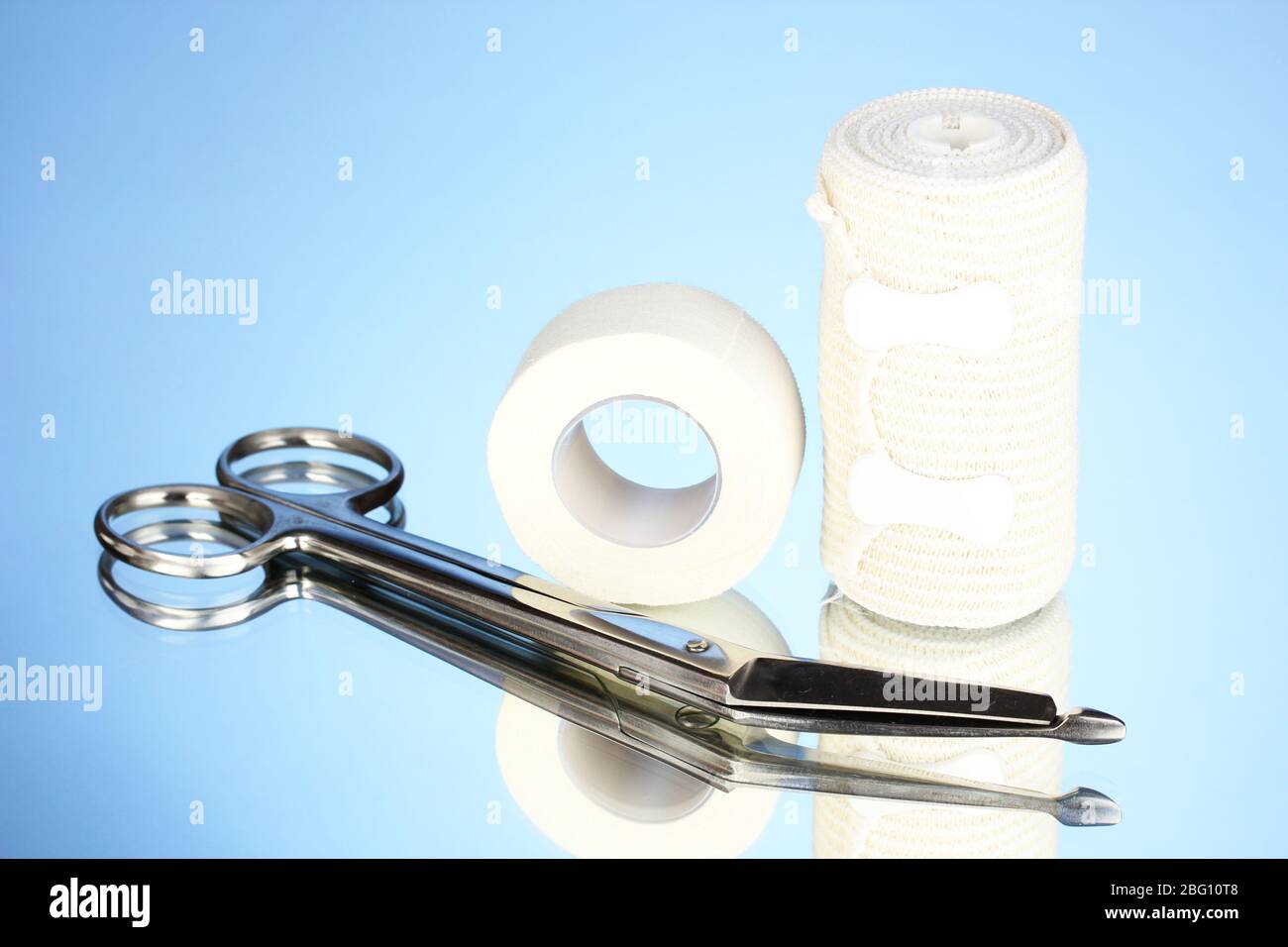 First aid kit for bandaging on blue background Stock Photo - Alamy