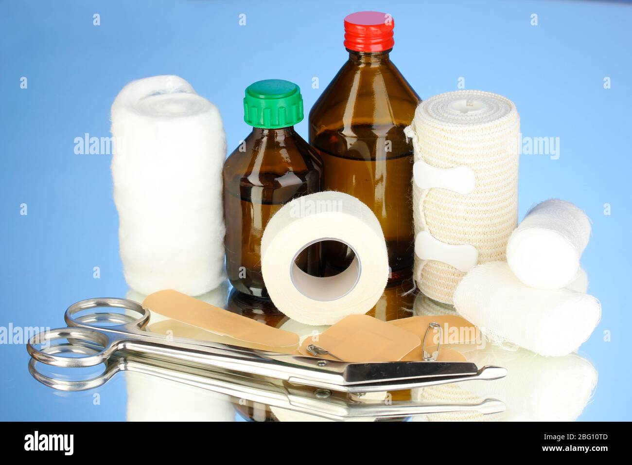 First aid kit for bandaging on blue background Stock Photo - Alamy