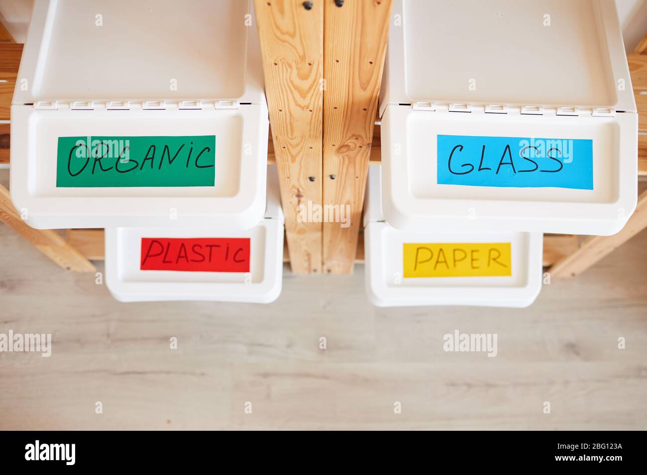 Top view background image of plastic bins labeled for storage and ...