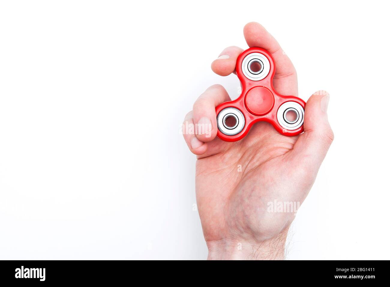Male hand holding popular fidget spinner toy Stock Photo - Alamy