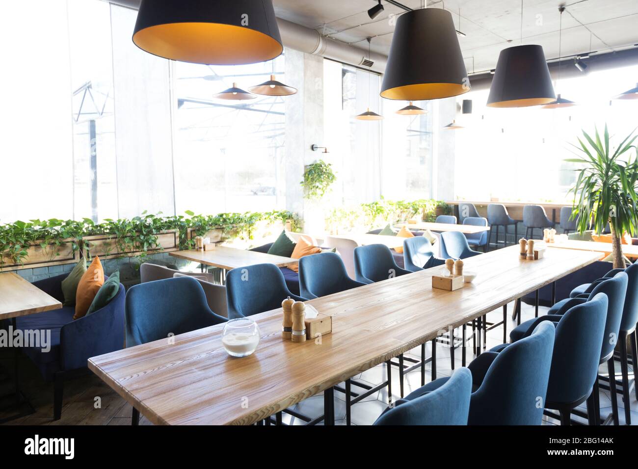 Light modern interior of urban restaurant or cafe with dining places ...