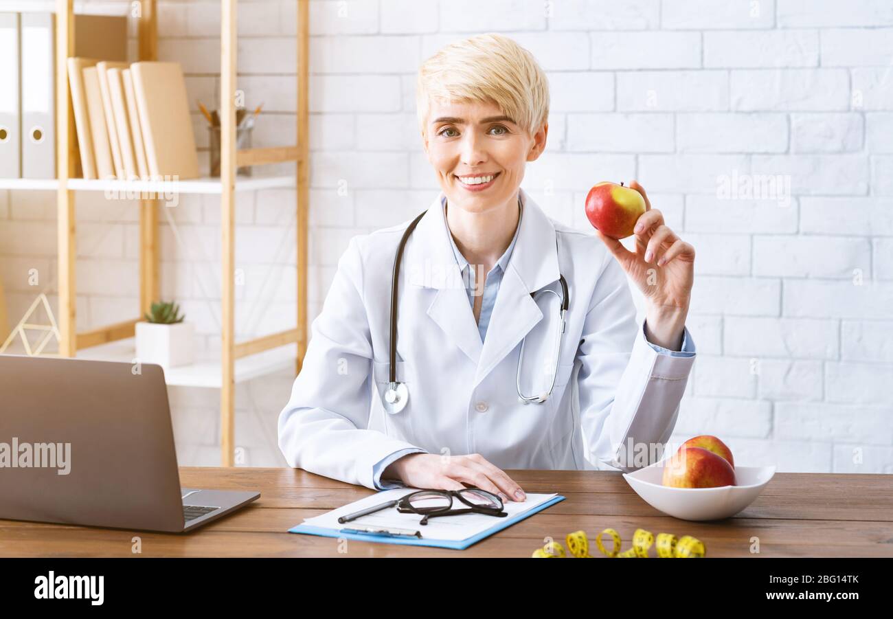 Doctor at table hi-res stock photography and images - Alamy