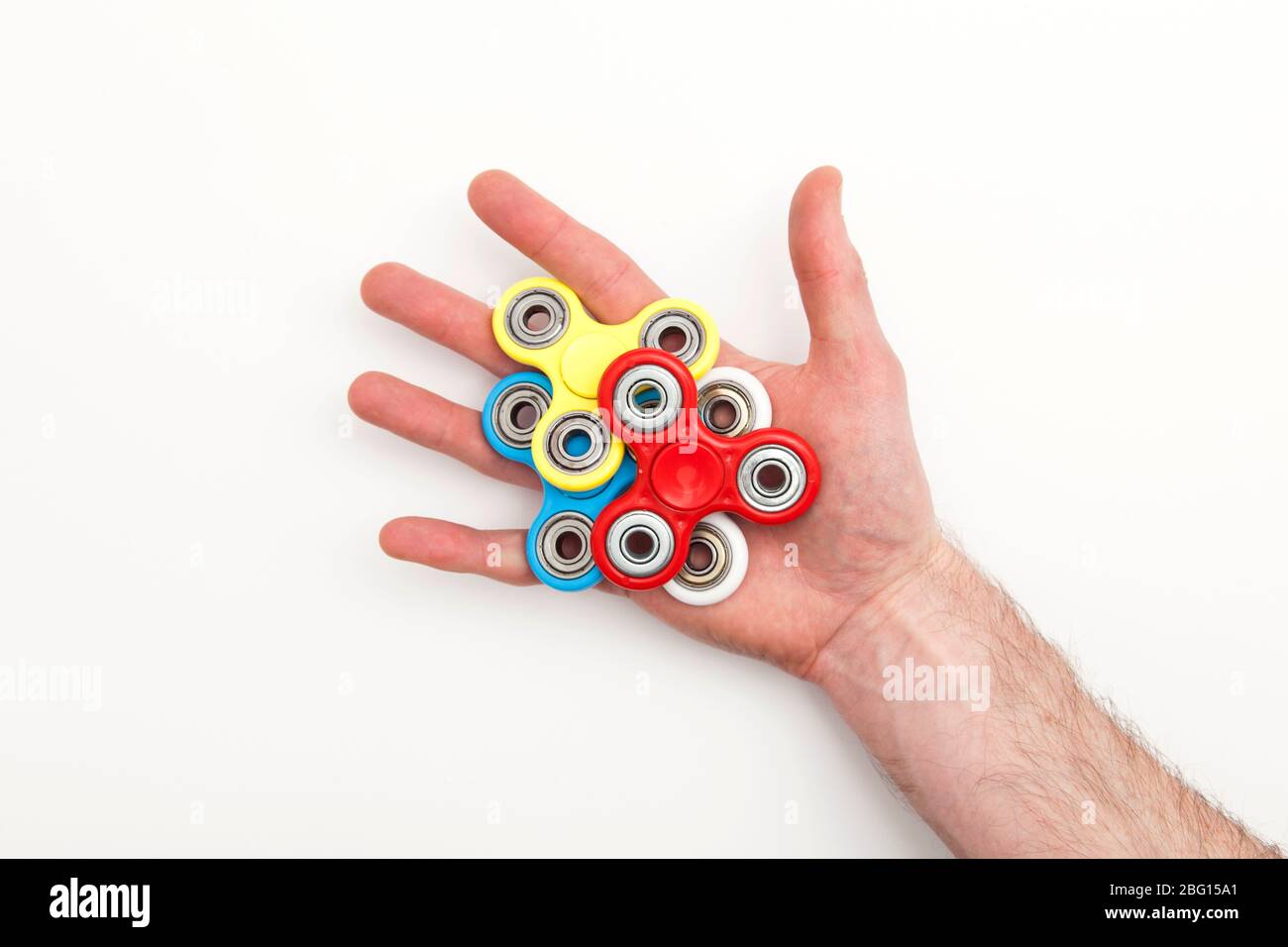 Male hand holding popular fidget spinner toy Stock Photo - Alamy