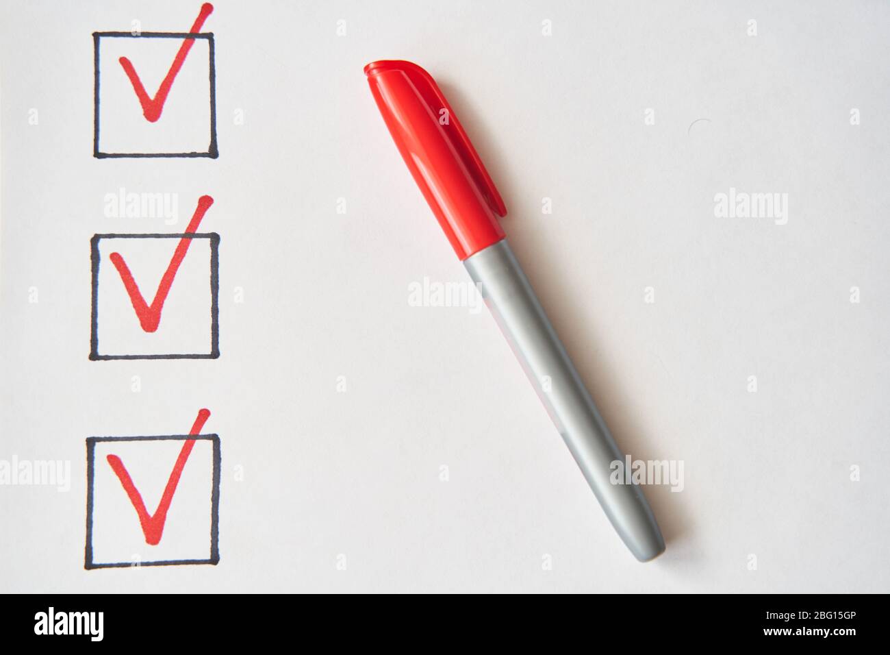 Checklist marked red with a red pen Stock Photo - Alamy