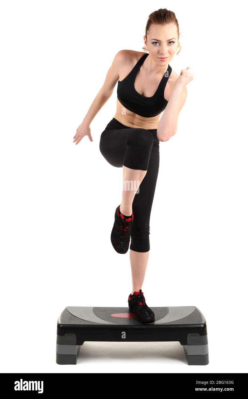 Young woman doing fitness exercises on stepper isolated on white Stock ...