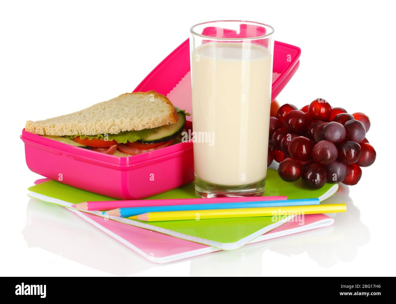 Lunch box with sandwich,milk,grapes and stationery isolated on white ...