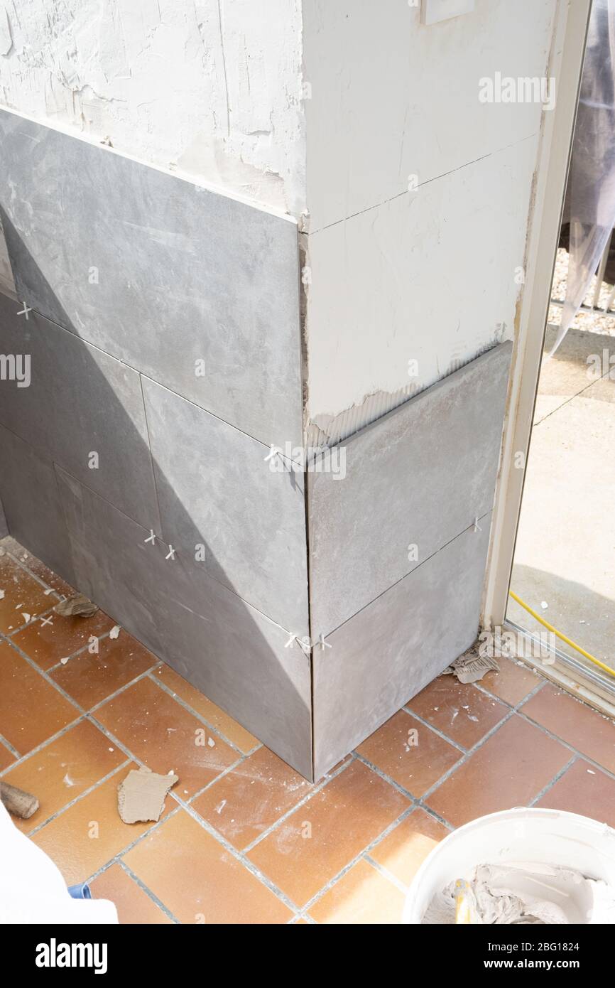 ceramic tile installation site with its tools Stock Photo - Alamy
