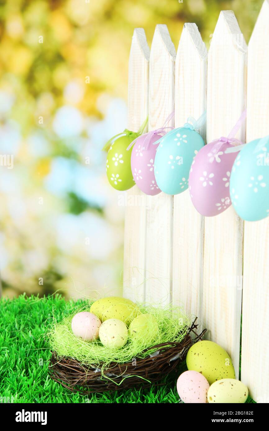 Art Easter background with eggs hanging on fence Stock Photo - Alamy