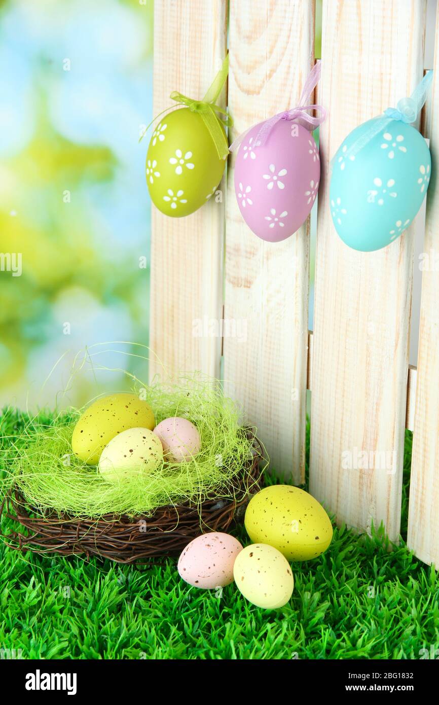 Art Easter background with eggs hanging on fence Stock Photo - Alamy