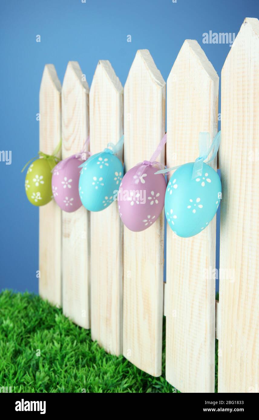 Art Easter background with eggs hanging on fence Stock Photo - Alamy