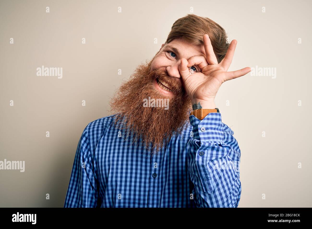 Handsome Irish redhead business man with beard standing over isolated ...