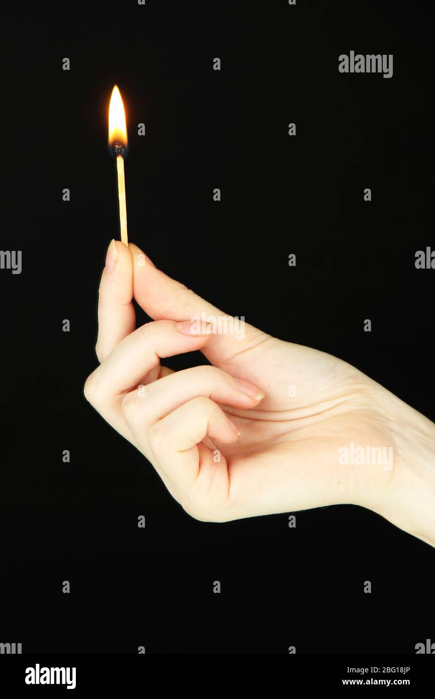 Burning lighter in female hand, isolated on black Stock Photo - Alamy