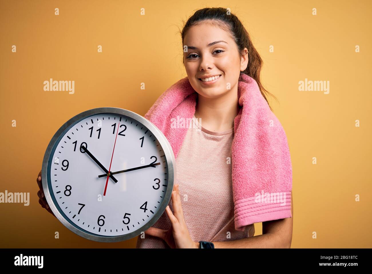 Young beautiful brunette sportswoman wearing towel doing countdown ...