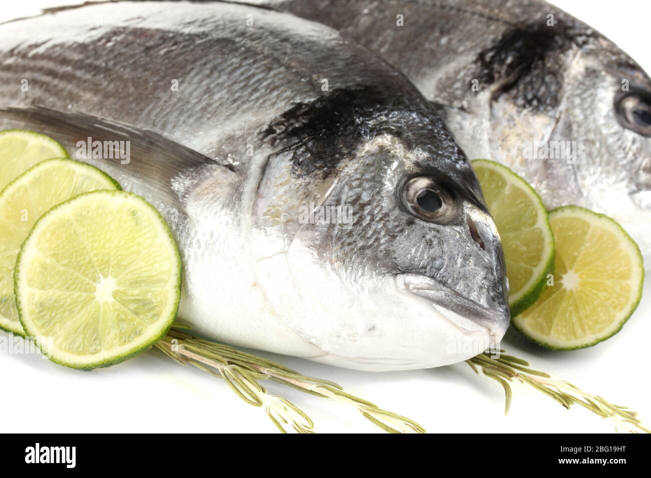 Two fish dorado with lemon isolated on white Stock Photo - Alamy
