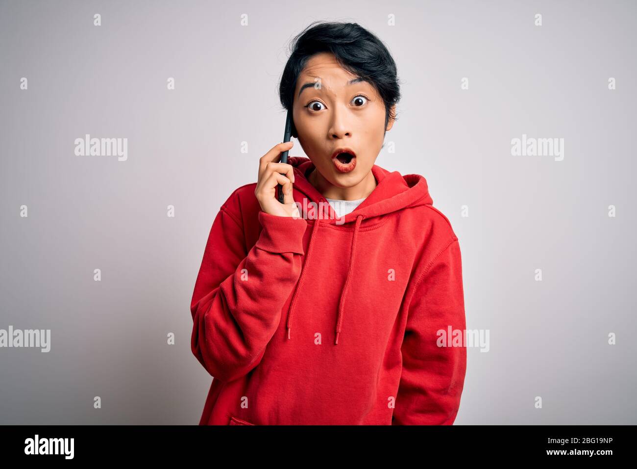 Young beautiful asian girl having conversation talking on the ...