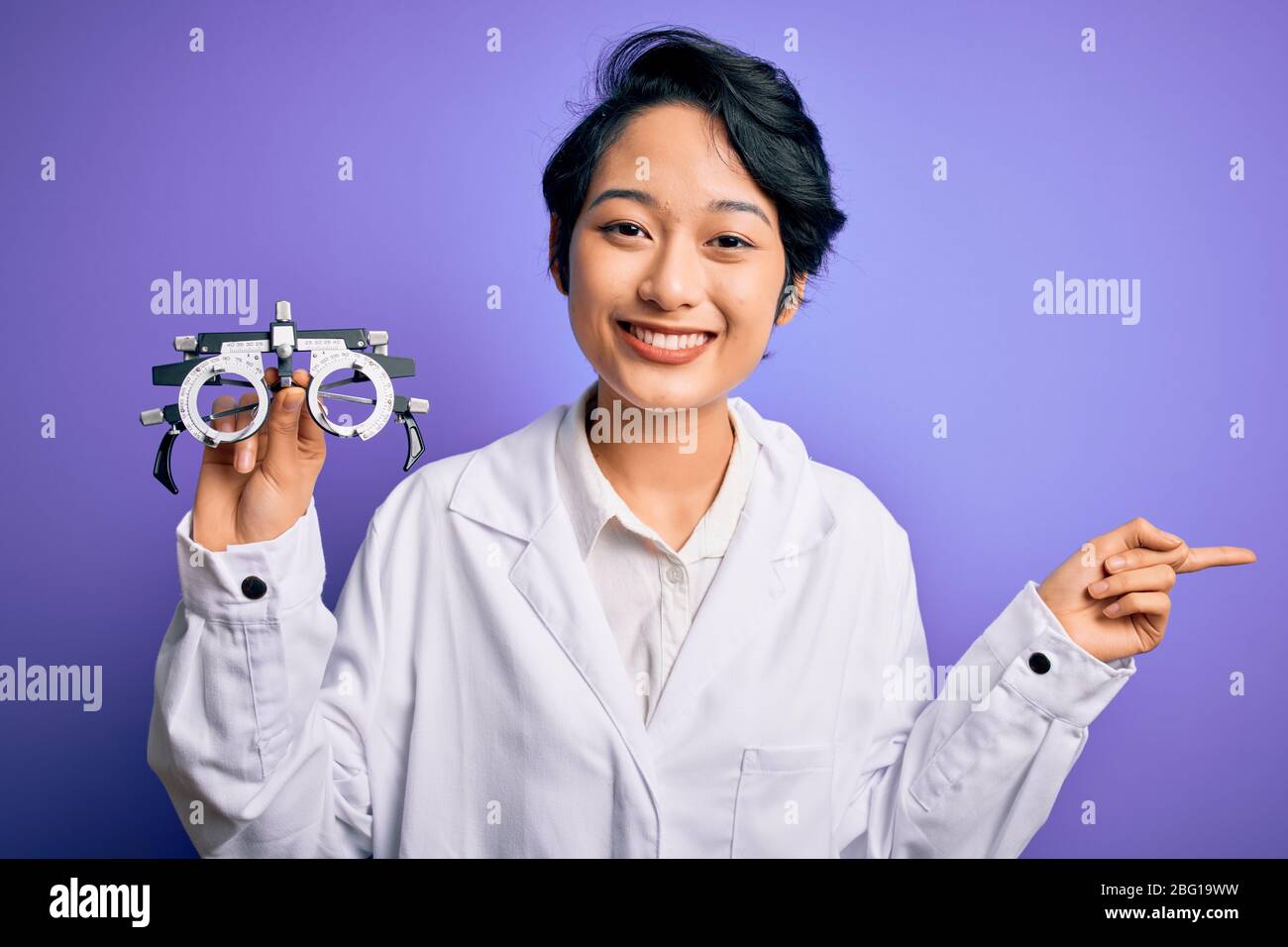 Beautiful asian optical girl wearing coat holding optometry glasses ...